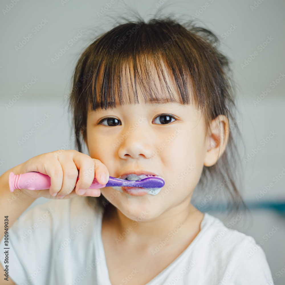 Little kids brushing teeth by herself as activity daily living in the ...