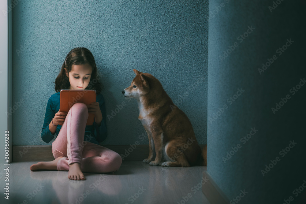 girl reading a story to her dog in the hallway at home Stock Photo ...
