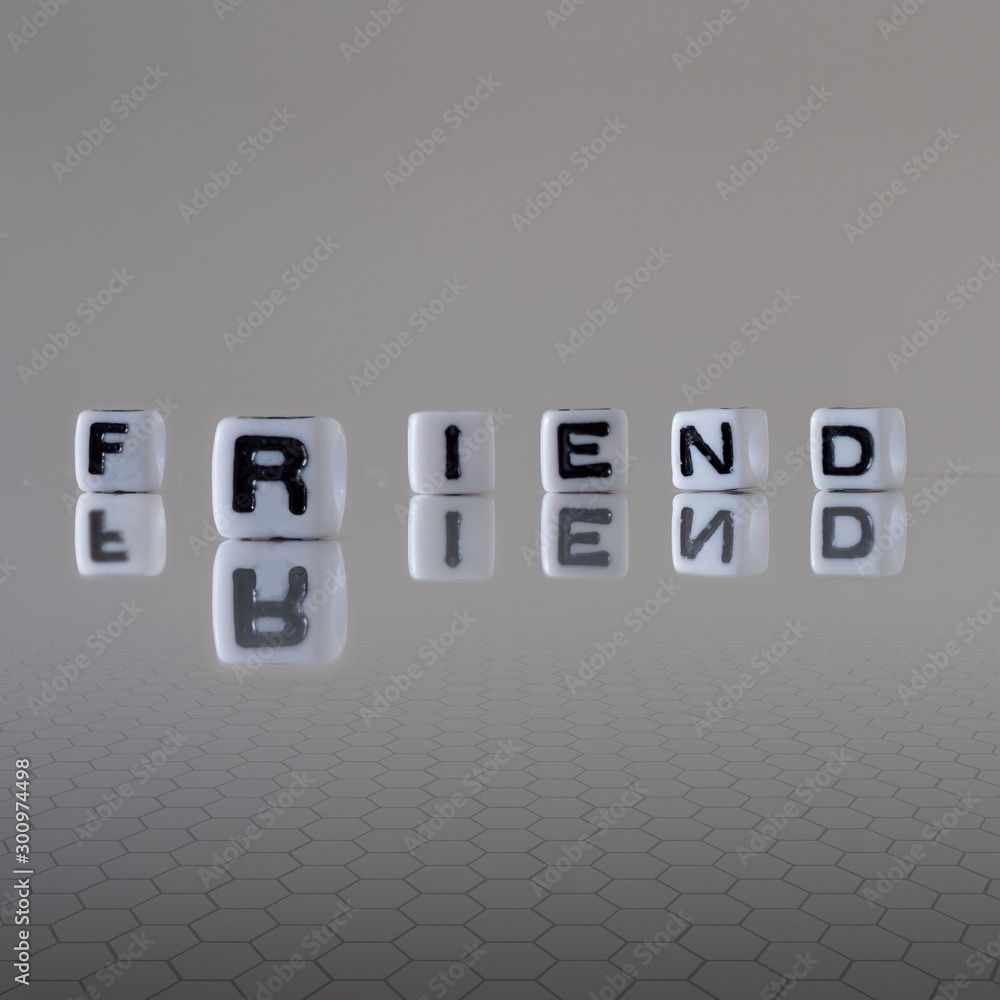 The concept of friend represented by black and white plastic letter ...