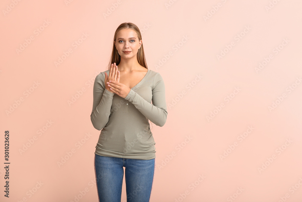 Young deaf mute woman using sign language on color background Stock ...
