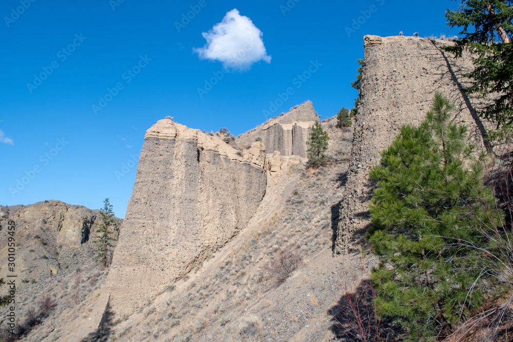 View of arid landscape, sand cliff formations, tall unstable tabletop ...