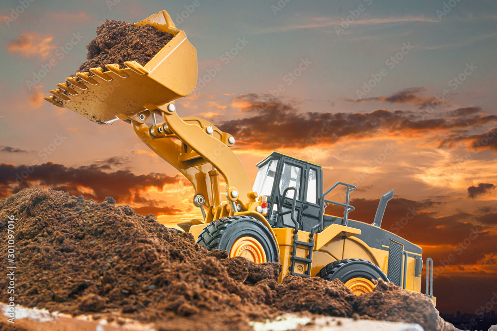 Wheel loader are digging the soil in the construction site on the ...