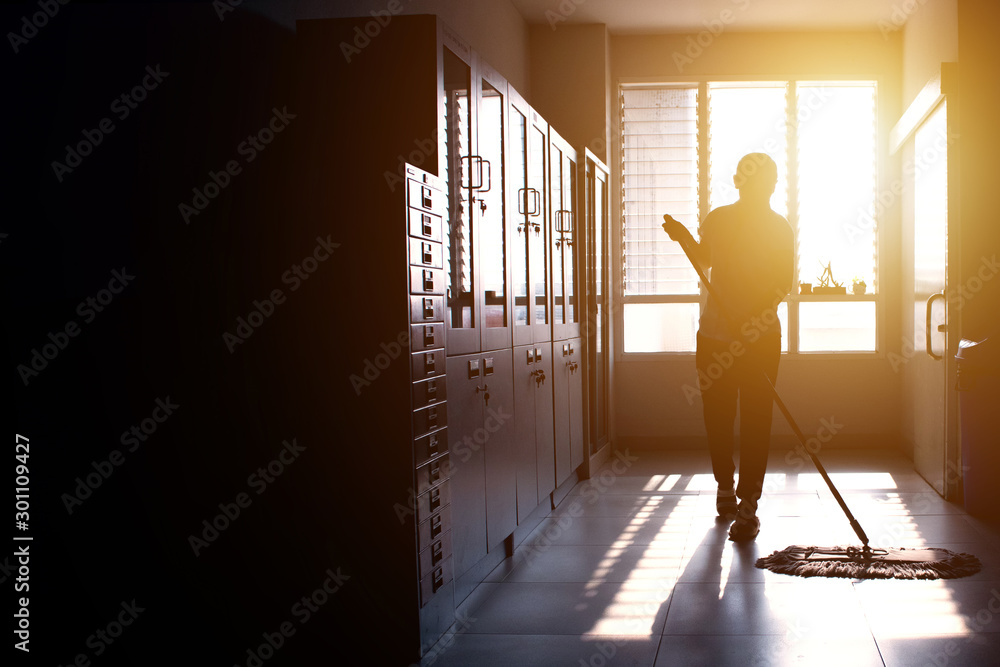 Janitor woman mopping floor in hallway office building or walkway after ...