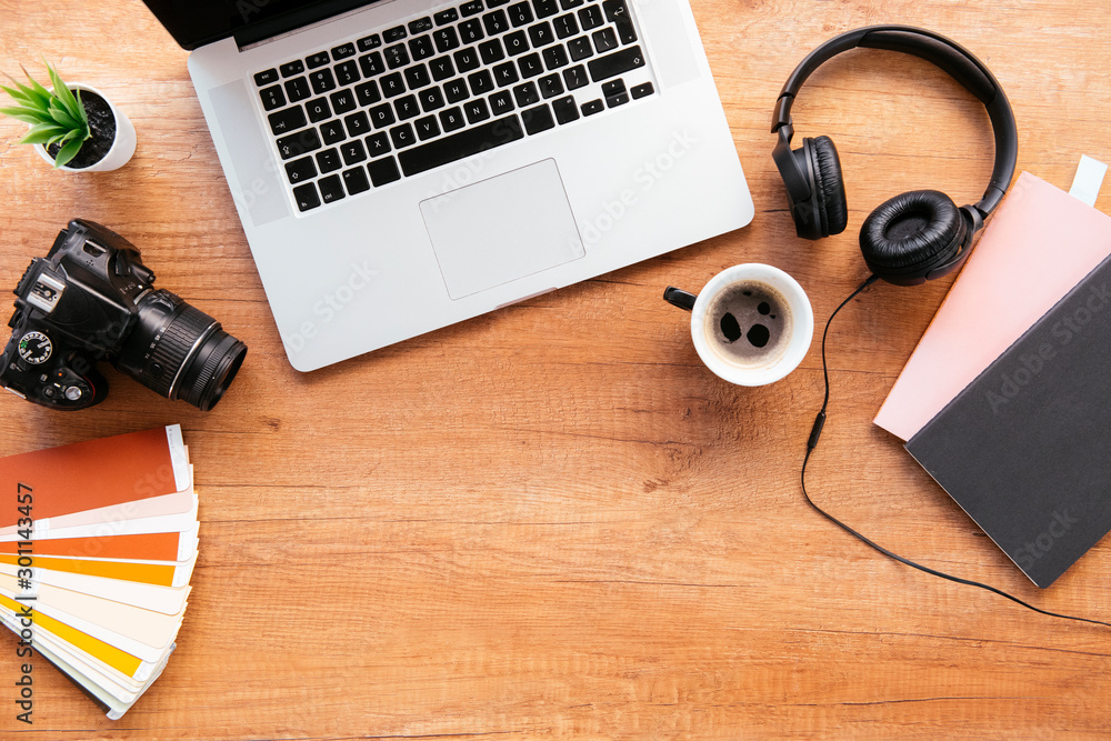 Top view of office table. Wood office desk table with laptop, cup of ...