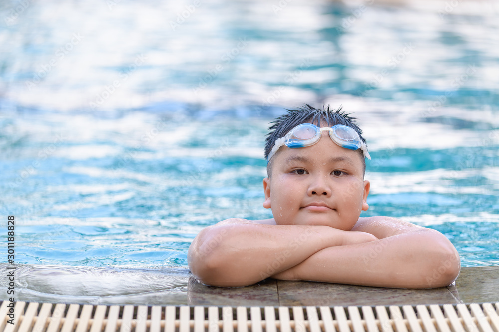 Obese fat boy wear goggle and smile in swimming pool, Stock Photo ...