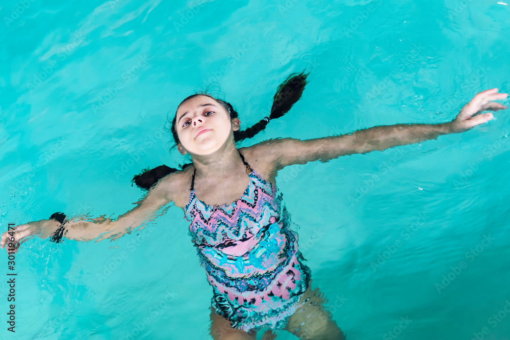 Girl swim in the pool. Happy girl play in the pool.Beautiful girl swim ...