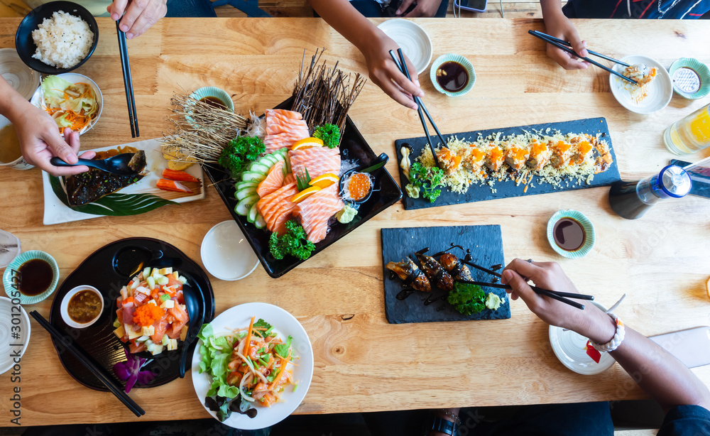 A set of sushi on a wooden table in a Japanese restaurant.Fresh salmon ...