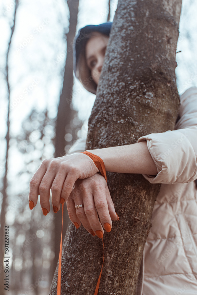 Restraint of women concept. A woman with her hands tied to a tree ...