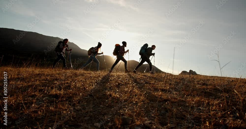 Four young people on hike adventure - Group of students trekking in ...