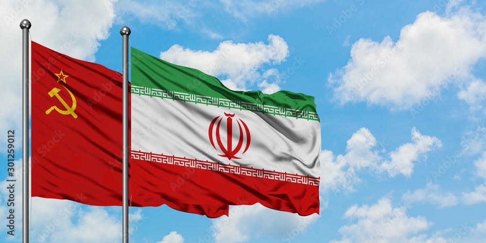 Soviet Union and Iran flag waving in the wind against white cloudy blue ...