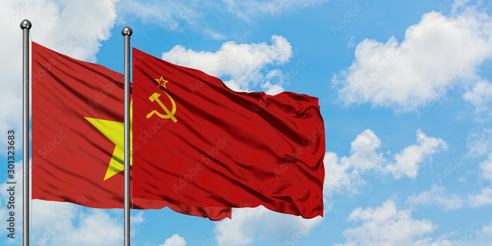 Vietnam and Soviet Union flag waving in the wind against white cloudy ...