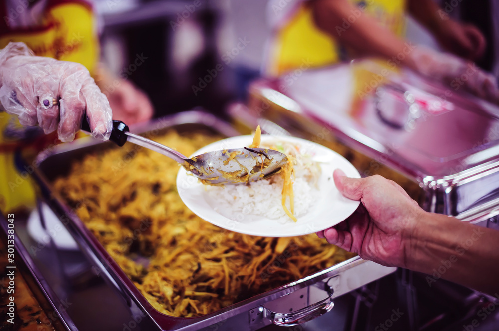 Volunteers provide free food to the poor with care : concept of begging ...