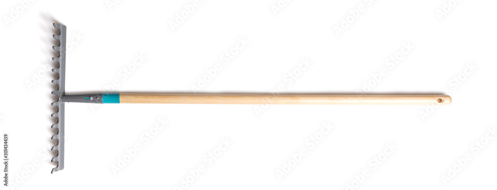 Rake with a wood handle isolated over a white background. Metal work ...
