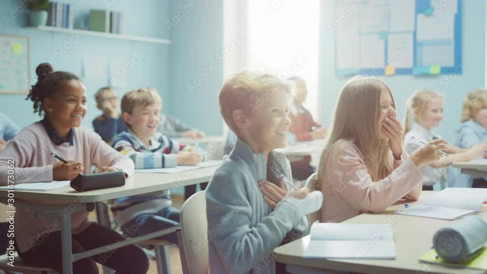 Elementary Classroom of Diverse Bright Children Listening to their ...