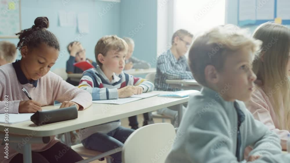 Elementary Classroom of Diverse Bright Children Listening Attentively ...