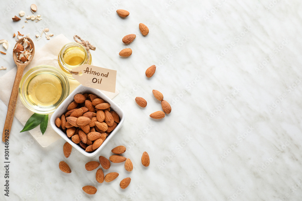 Tasty almond oil on white background Stock Photo | Adobe Stock