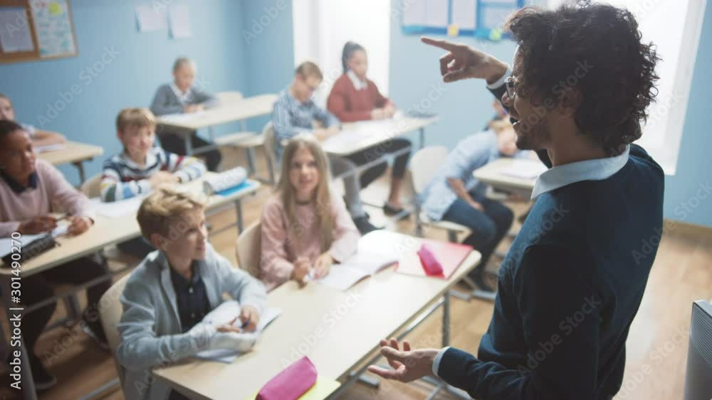 Elementary Classroom of Diverse Bright Children Listening to the ...