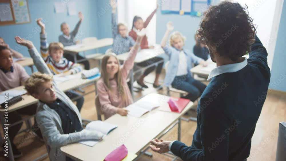 Elementary Classroom of Diverse Bright Children Listening to the ...