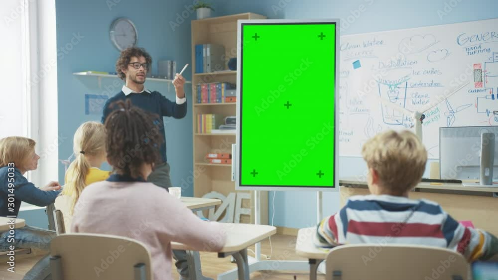 In the Elementary School Classroom: Teacher Uses Vertical Green Mock-up ...