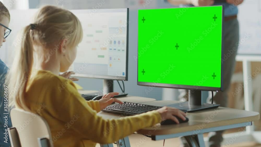 Elementary School Computer Science Classroom: Cute Little Girl Uses ...