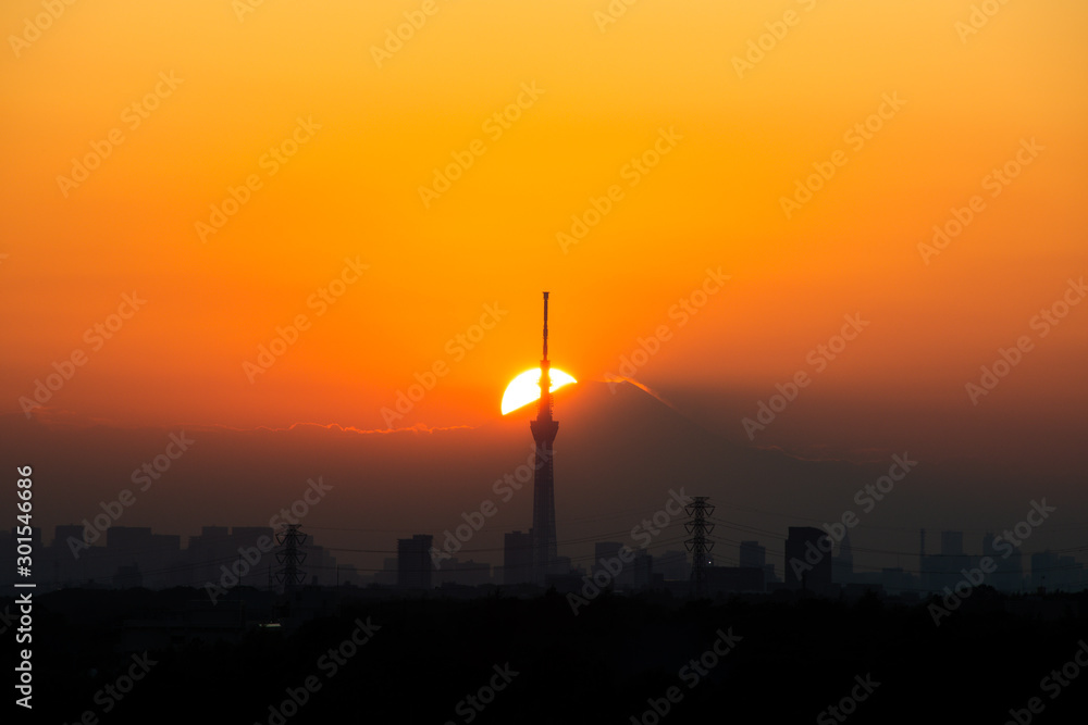 Sun setting behind Tokyo Skytree and Mount Fuji in autumn, from Chiba ...