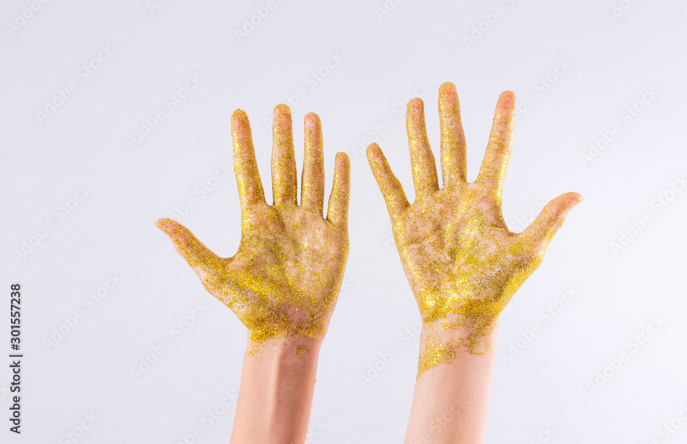 Female hands in gold sparkles. Sparkling hands on a light background ...