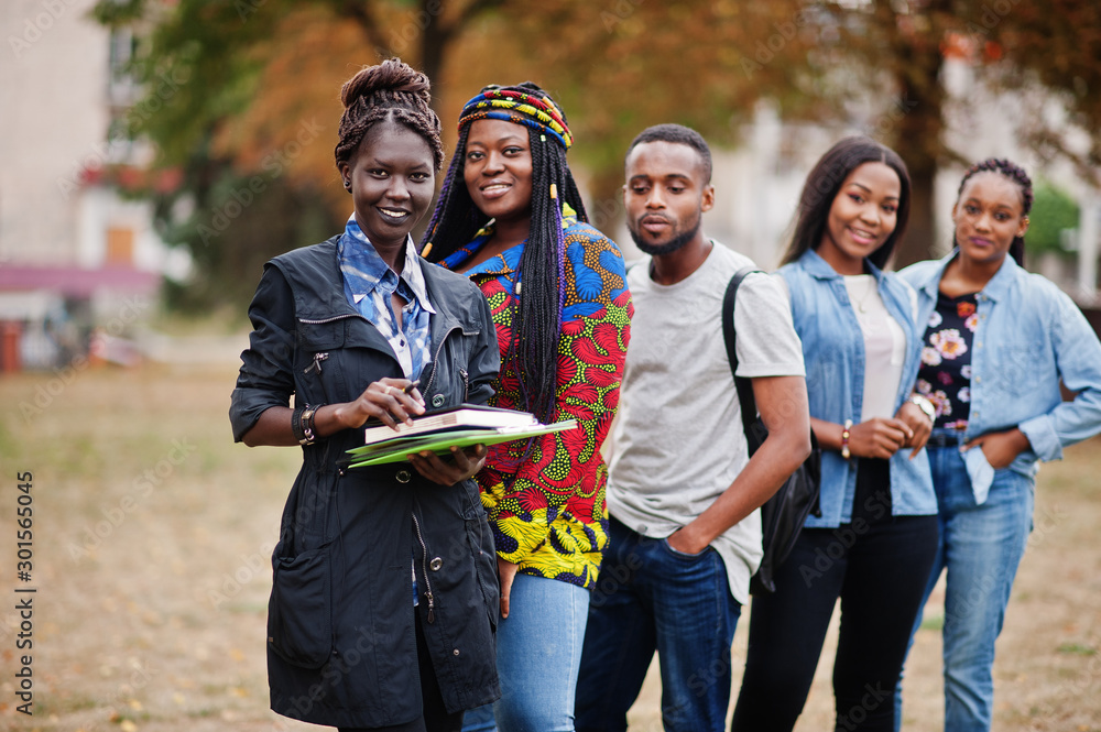 Row of group five african college students spending time together on ...