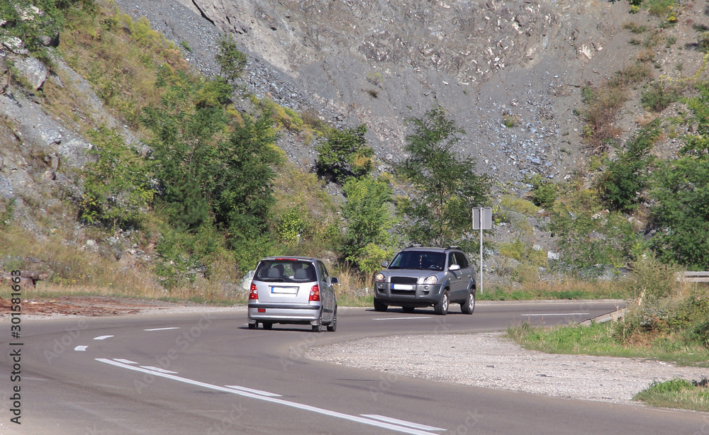 Two cars on the road through gorge Stock Photo | Adobe Stock