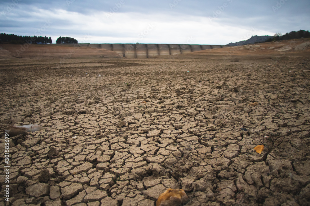 Big cracks in an arid an dry ground of a desert caused by severe ...
