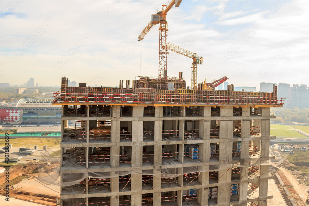Fotka „Construction workers on scaffold. Scaffolding staging is ...