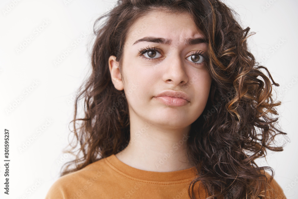 Headshot disappointed displeased upset curly-haired cute armenian girl ...