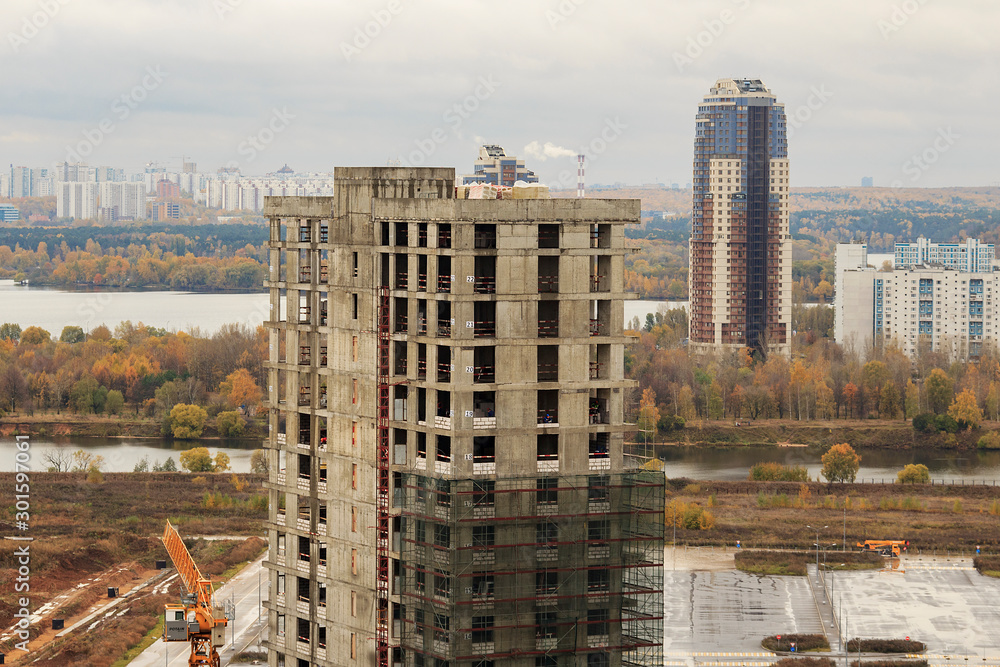 Tall building under construction with scaffolds. Construction site ...