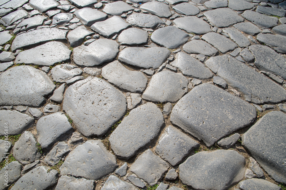 A fragment of the original cobblestone pavement of time-worn stones ...