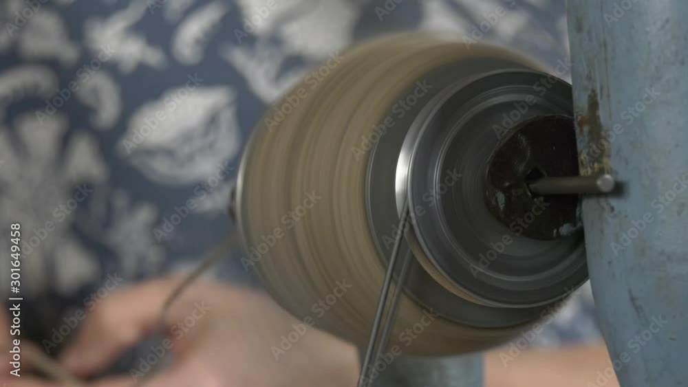 Rotating spindle in a manual woolen lock during operation. Extra close ...