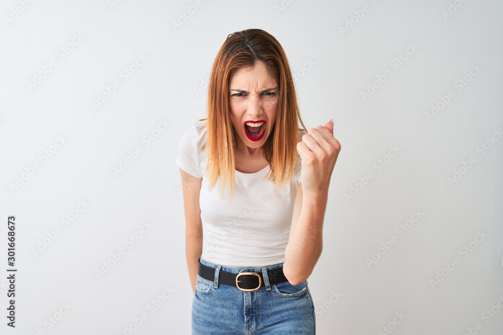 Beautiful redhead woman wearing casual t-shirt standing over isolated ...