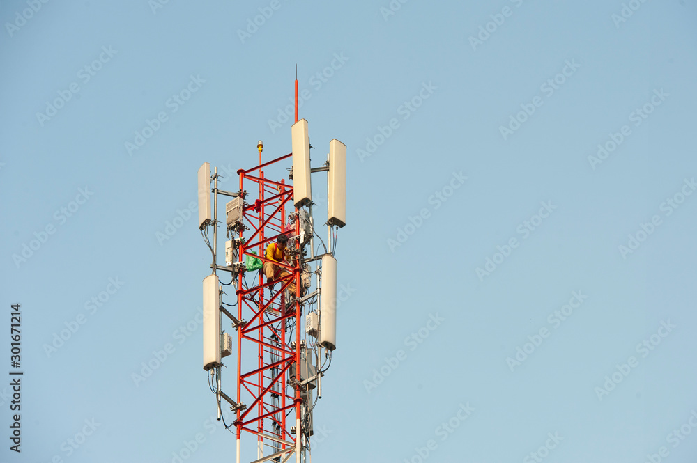 Tower climber and man worker is working on cellular tower system ...