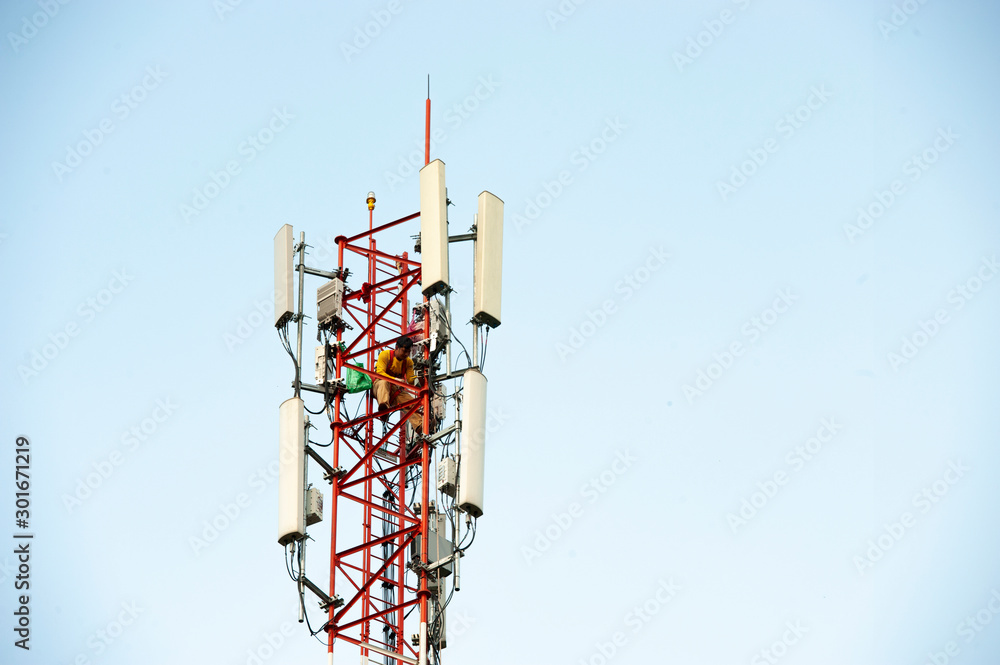 Tower climber and man worker is working on cellular tower system ...