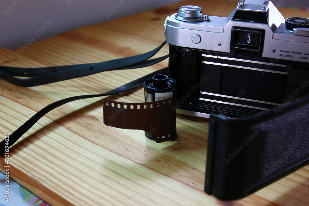 manual camera film with color film on wood floor,grain in photo is ...