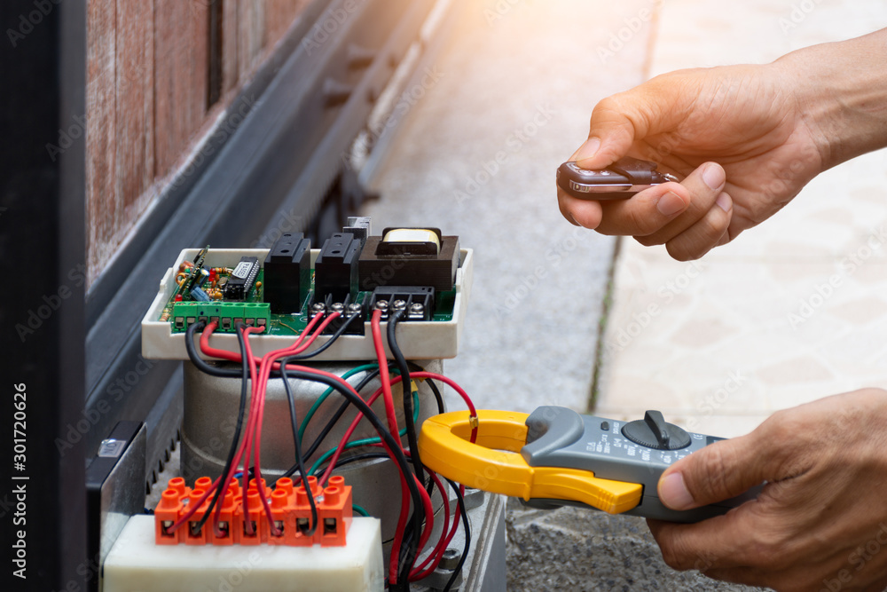 Technician man hand pressing remote control while repair and using ...