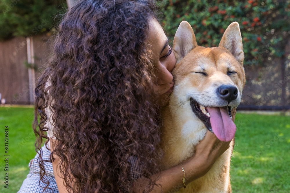 Animals lovers lifestyle. Portrait of ethnic moroccan woman hugging and ...