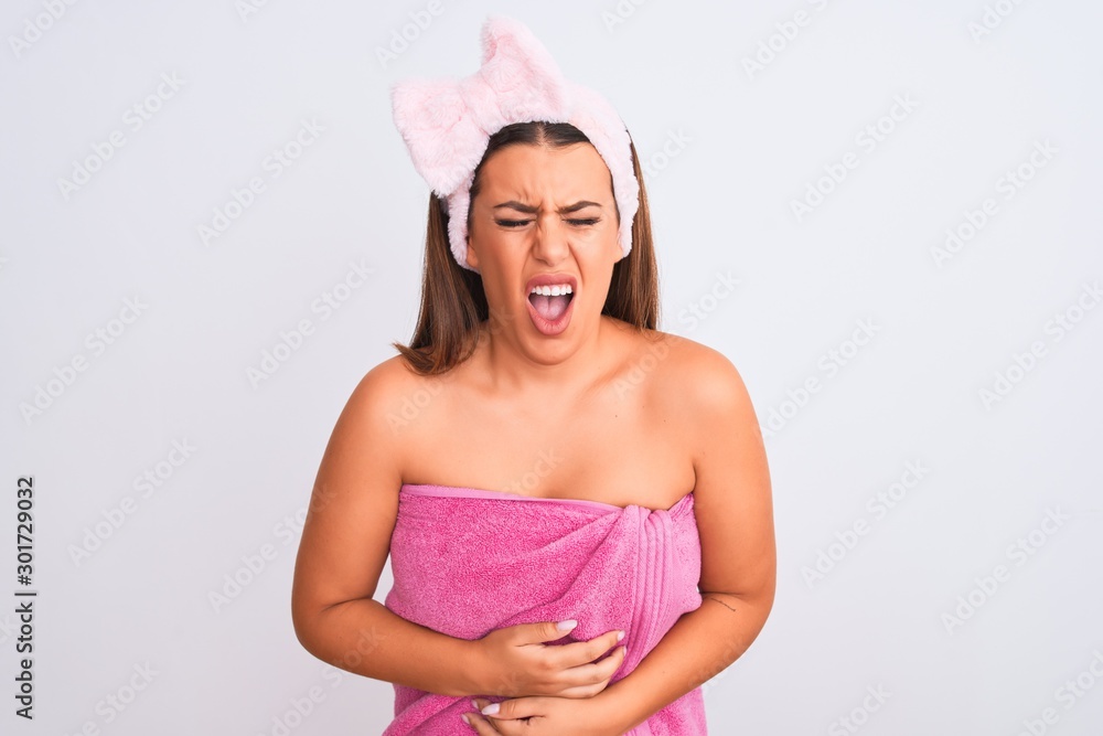 Beautiful young woman wearing pink shower towel and beauty headband ...