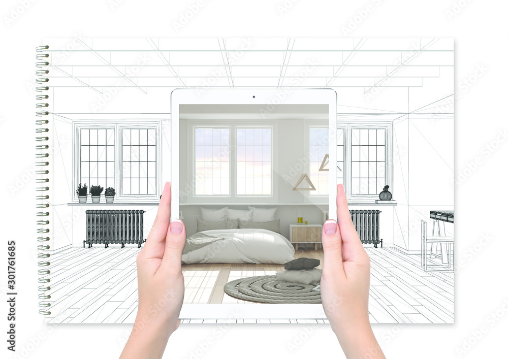 Hands holding tablet showing bedroom with bed, notebook with blueprint ...