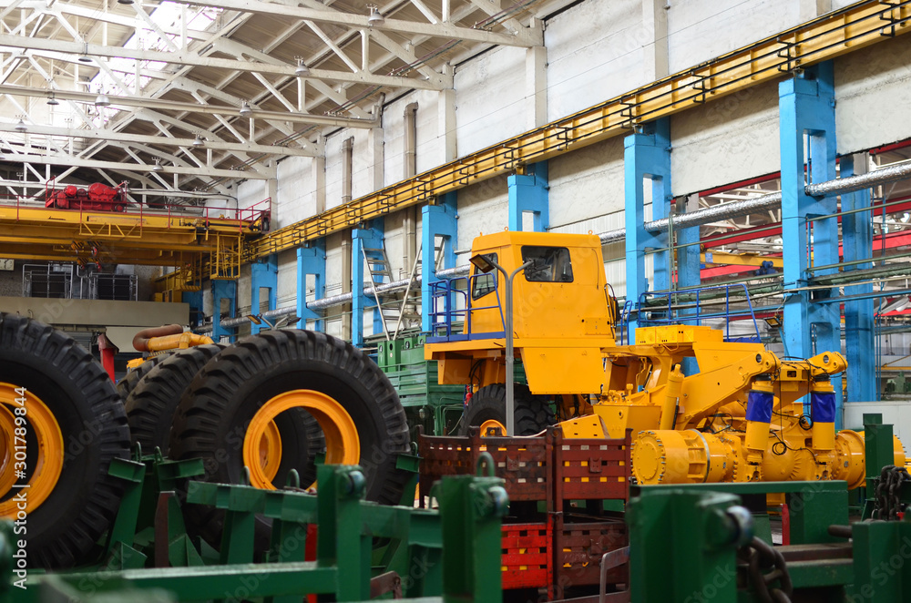 Production process of heavy mining trucks at the factory. Dump truck on ...