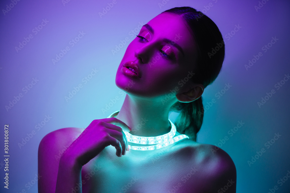 High Fashion model girl in neon lights posing in studio, portrait of ...