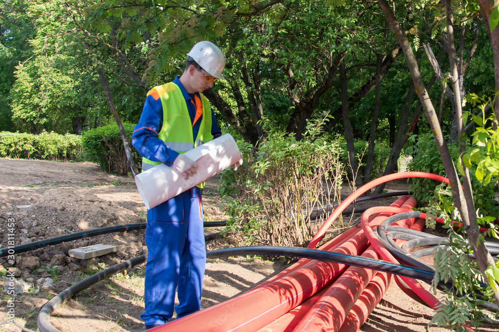 builder checks pipe layout on paper Stock Photo | Adobe Stock