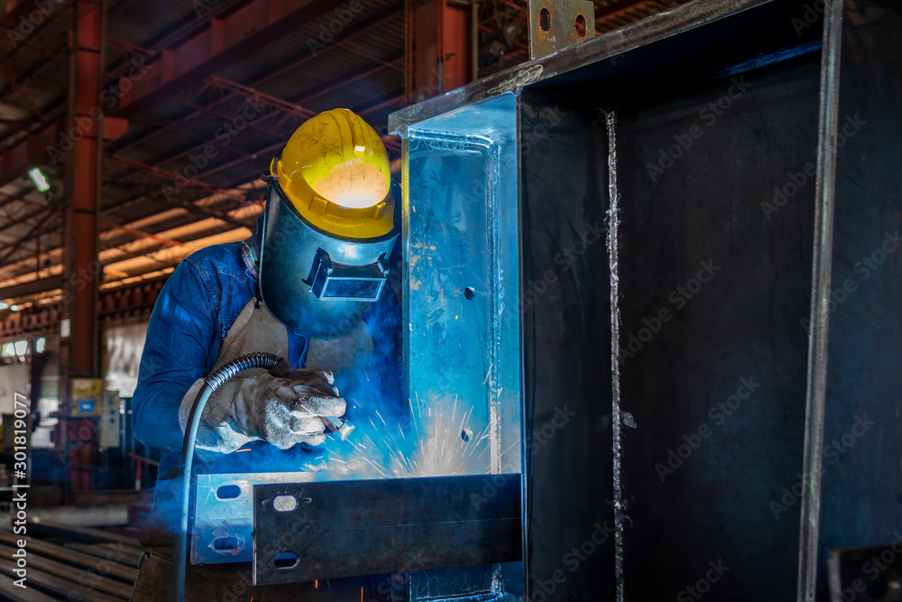 The welder is welding a column steel structure work with process Flux ...