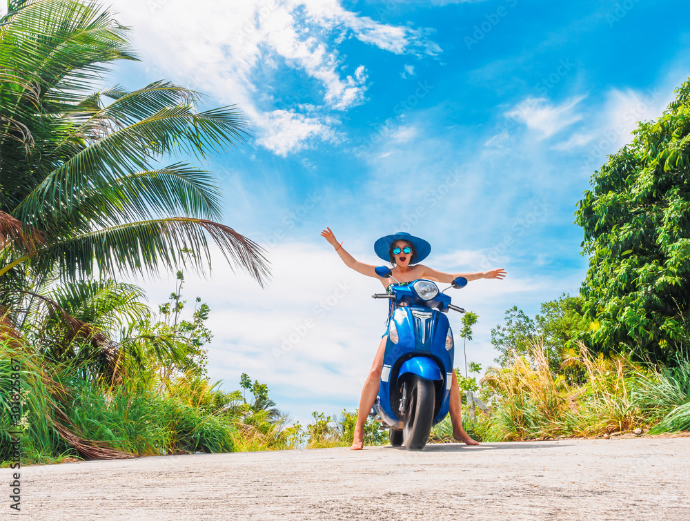 Crazy funny woman with flying hair riding a motorbike on a blue sky and ...