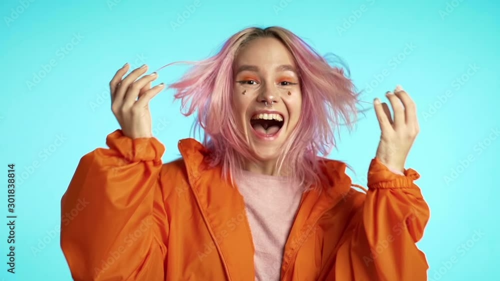 Excited happy screaming woman with unusual pink hairstyle. Portrait of ...