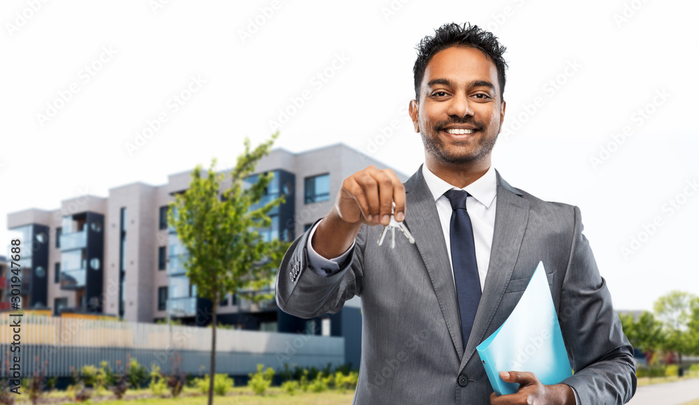 real estate business and people concept - indian man realtor with keys ...