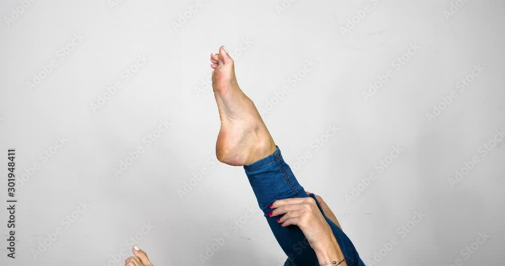 Woman Taking Off Jeans From One Leg And Teasing With White Background ...